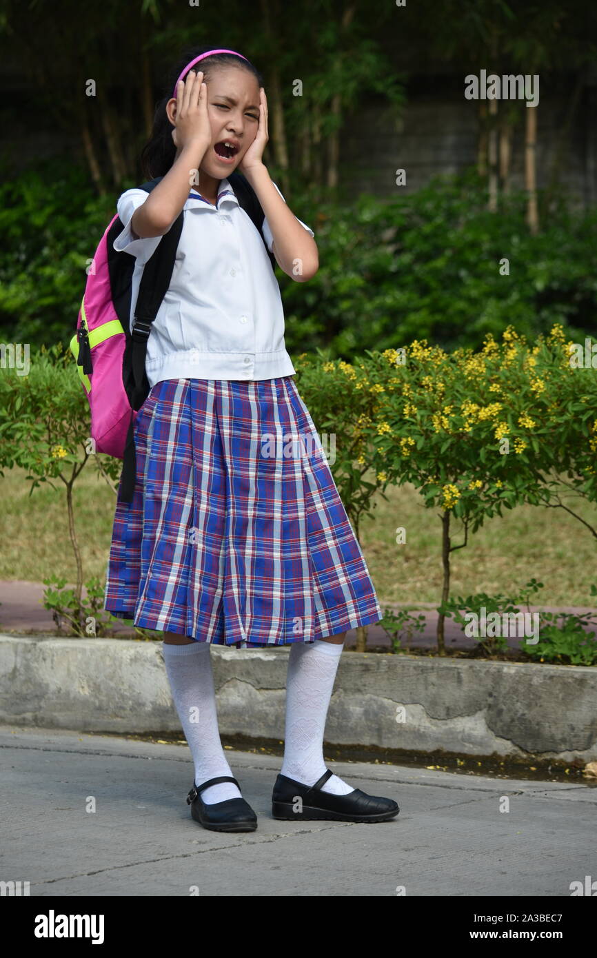 Anxious Asian Girl Student Wearing Uniform With Books Stock Photo - Alamy