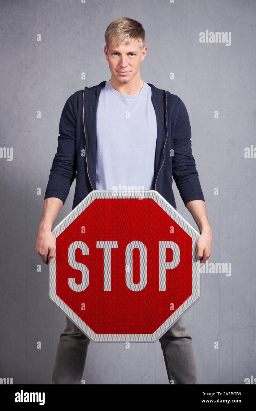 Man showing stop sign Stock Photo - Alamy