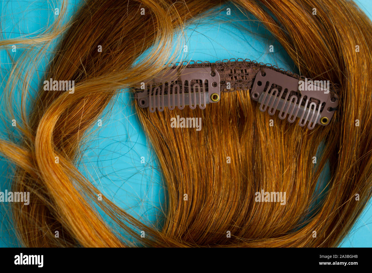 Hair for extension on the blue background Stock Photo - Alamy