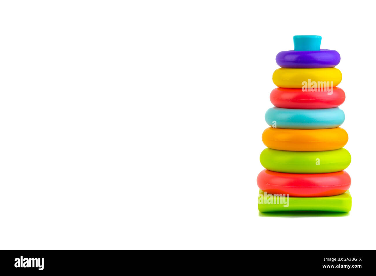 Plastic toy pyramid on a white background. Games and Copy space concept ...