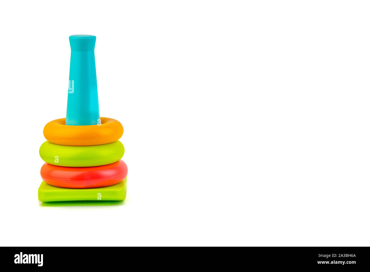 Plastic toy pyramid on a white background. Games and Copy space concept ...