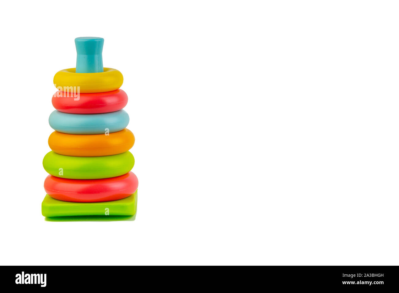 Plastic toy pyramid on a white background. Games and Copy space concept ...