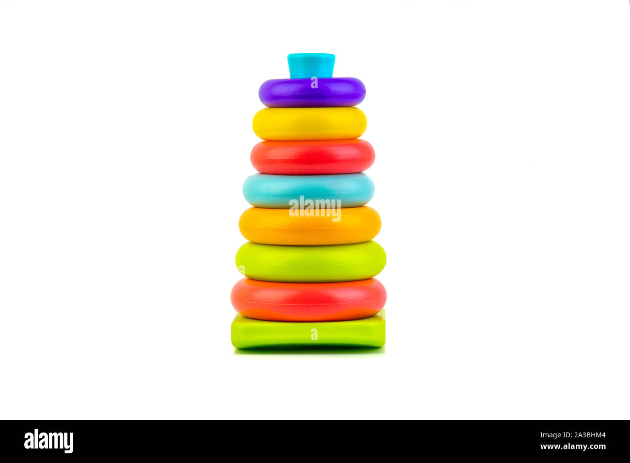 Plastic toy pyramid on a white background. Games and Copy space concept ...