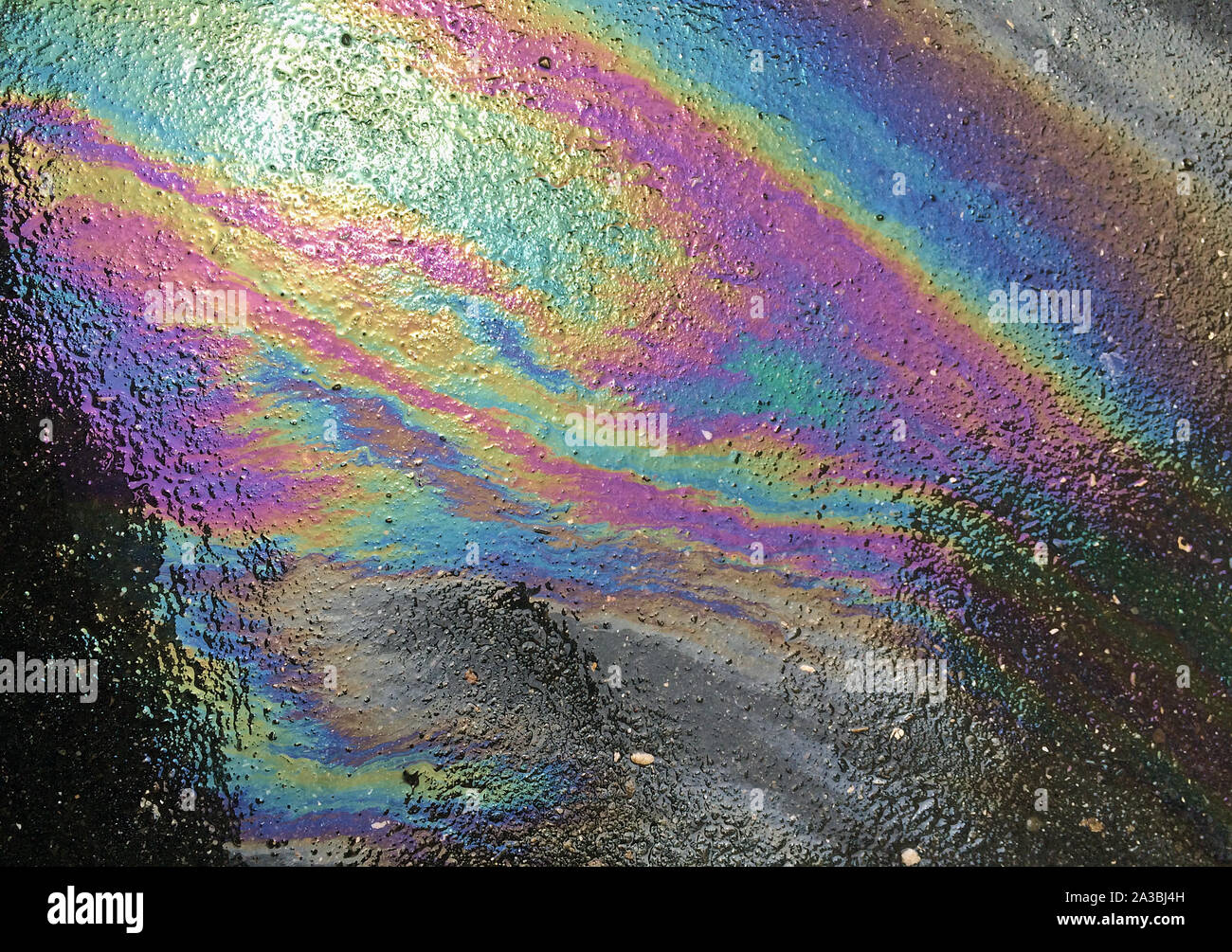 Oil spill pattern on asphalt Stock Photo - Alamy
