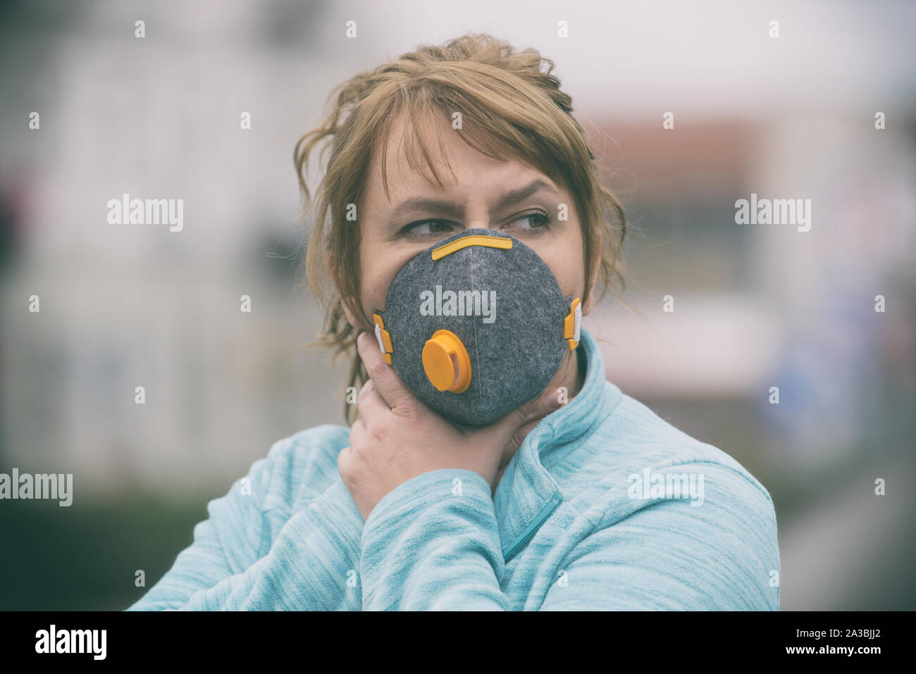 Woman wearing a real anti-pollution, anti-smog and viruses face mask ...