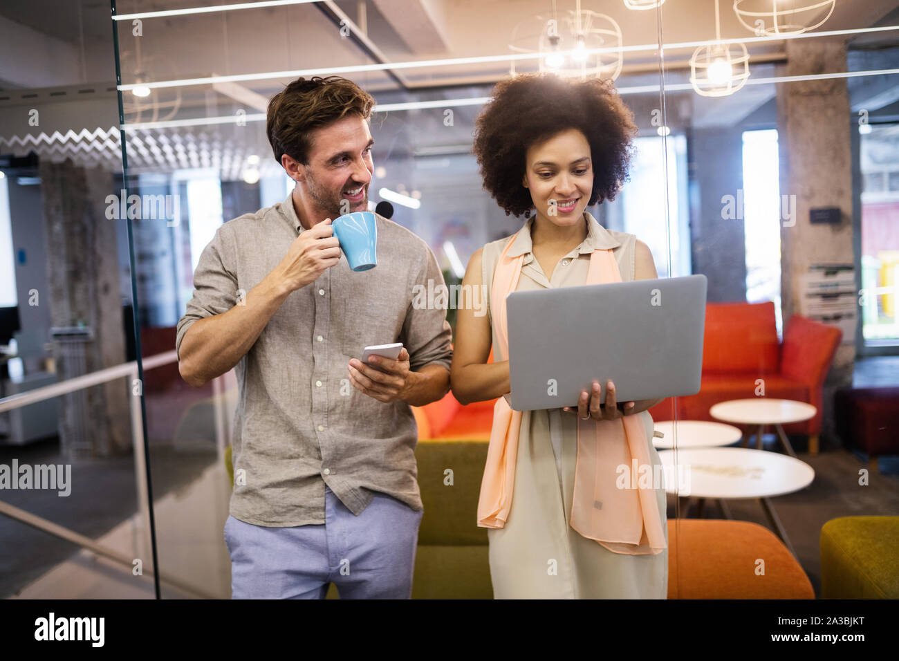 Team of colleagues brainstorming together while working in modern ...
