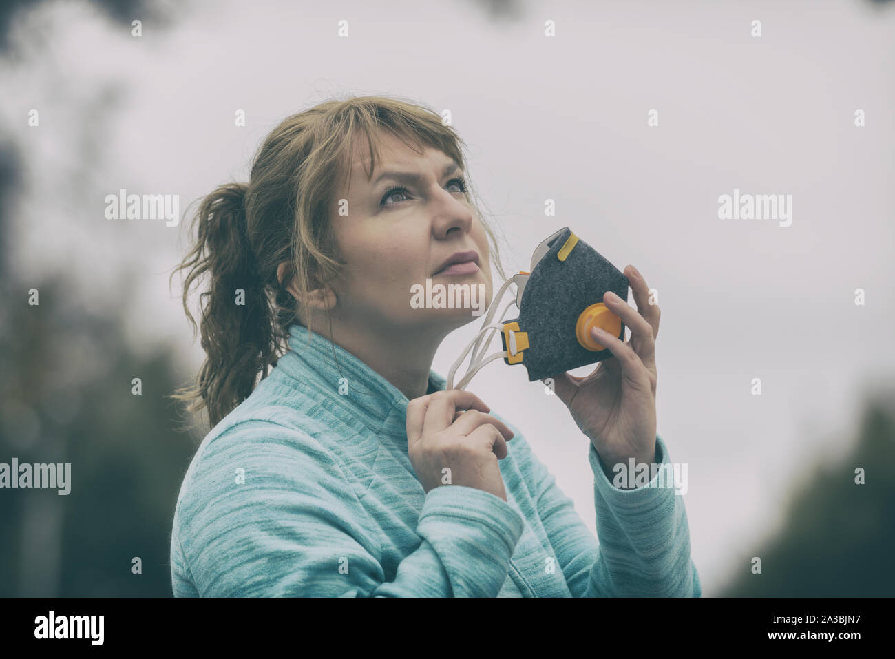 Woman wearing a real anti-pollution, anti-smog and viruses face mask ...