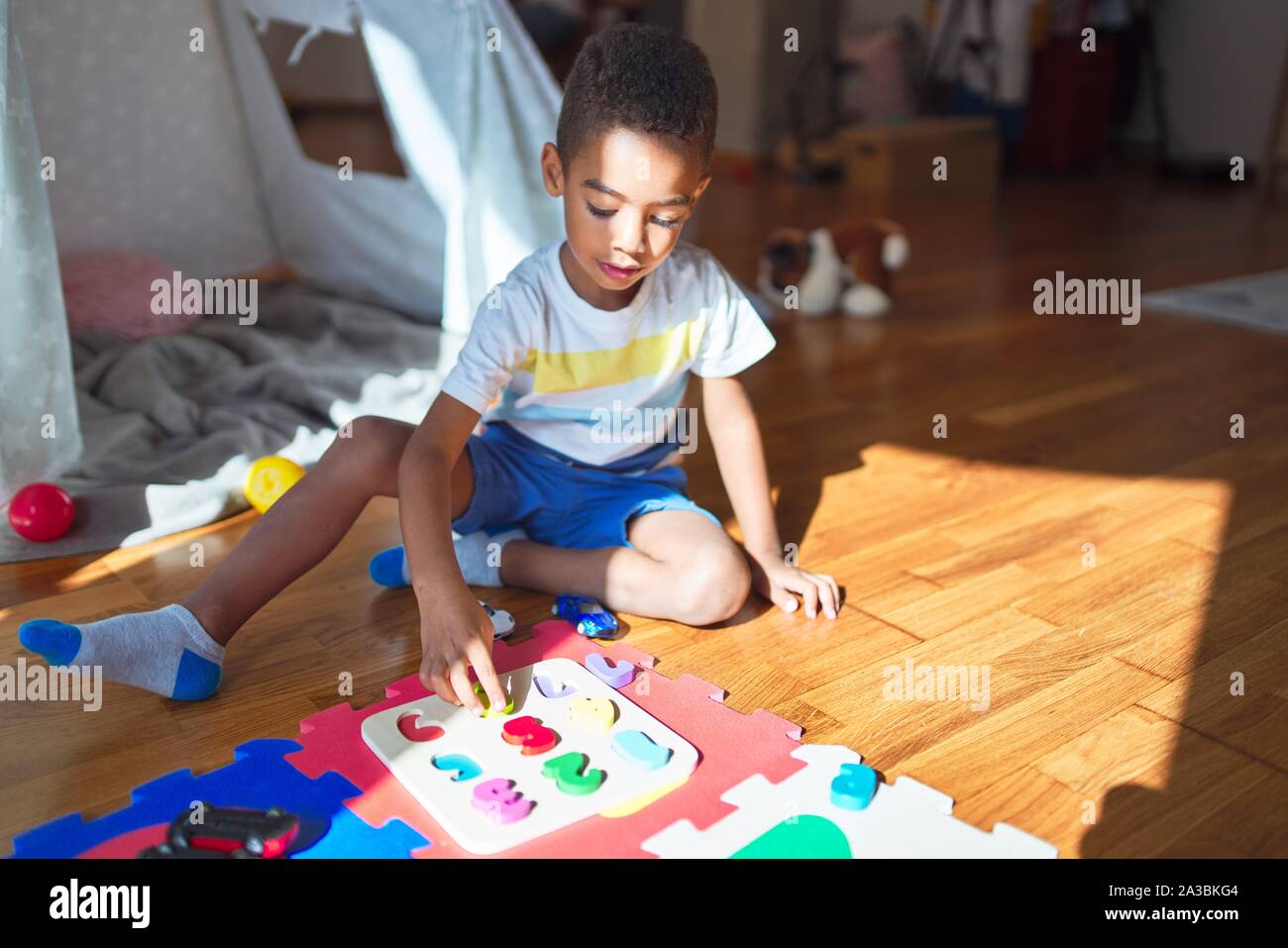 Beautiful african american toddler playing with maths game using ...
