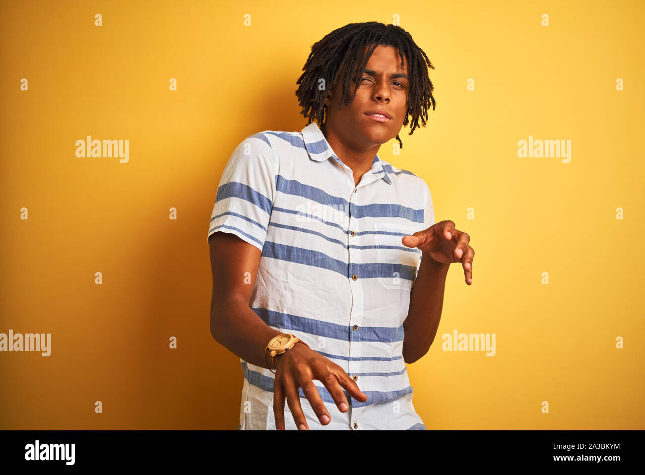 Afro american man with dreadlocks wearing striped shirt over isolated ...