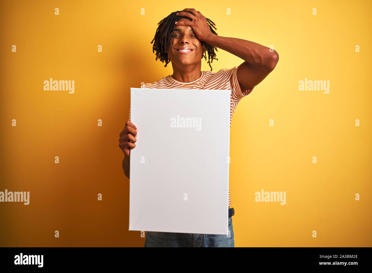 Afro american man with dreadlocks holding banner over isolated yellow ...
