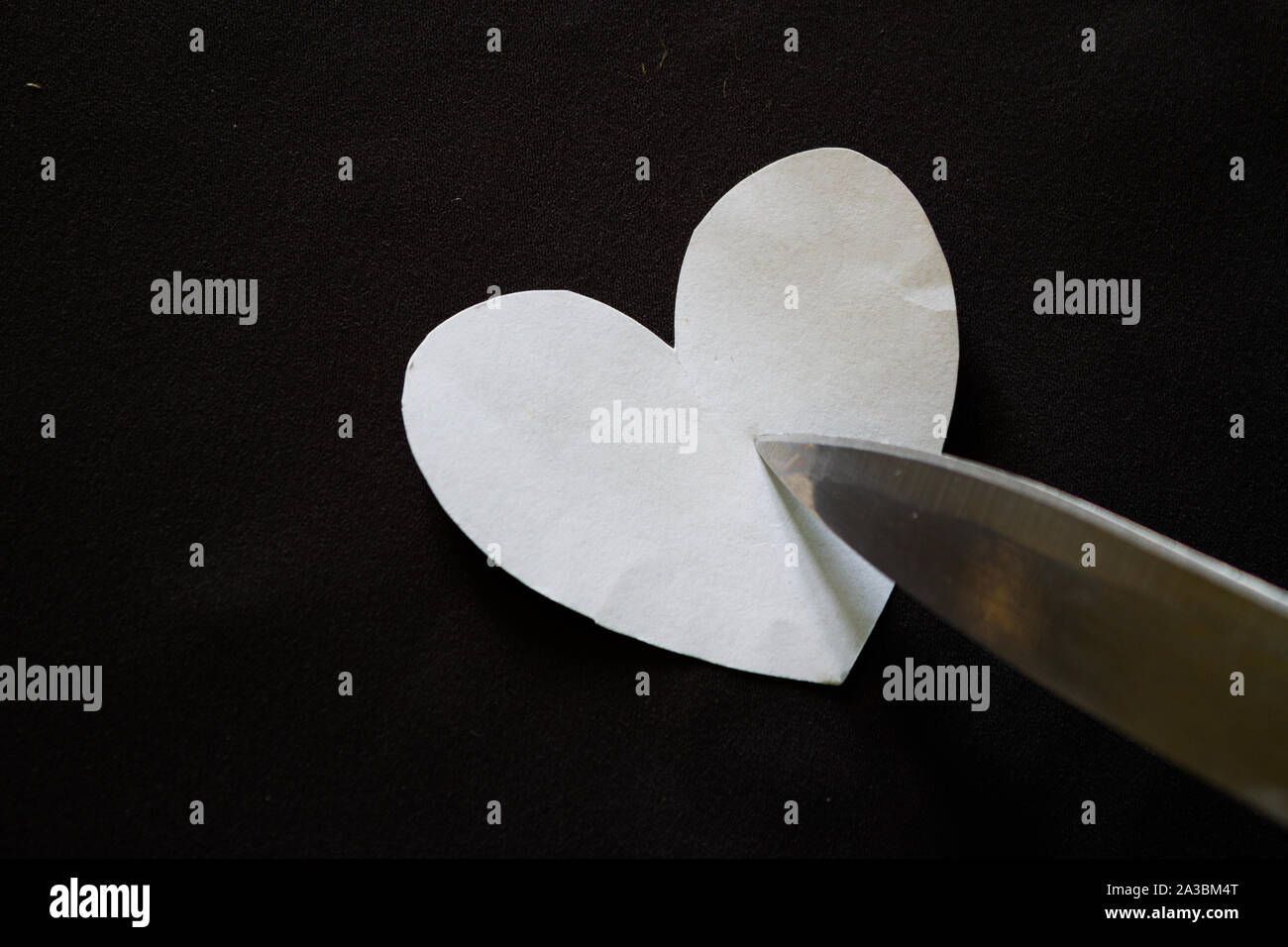 Stabbed Heart on black background. Broken heart concept Stock Photo - Alamy