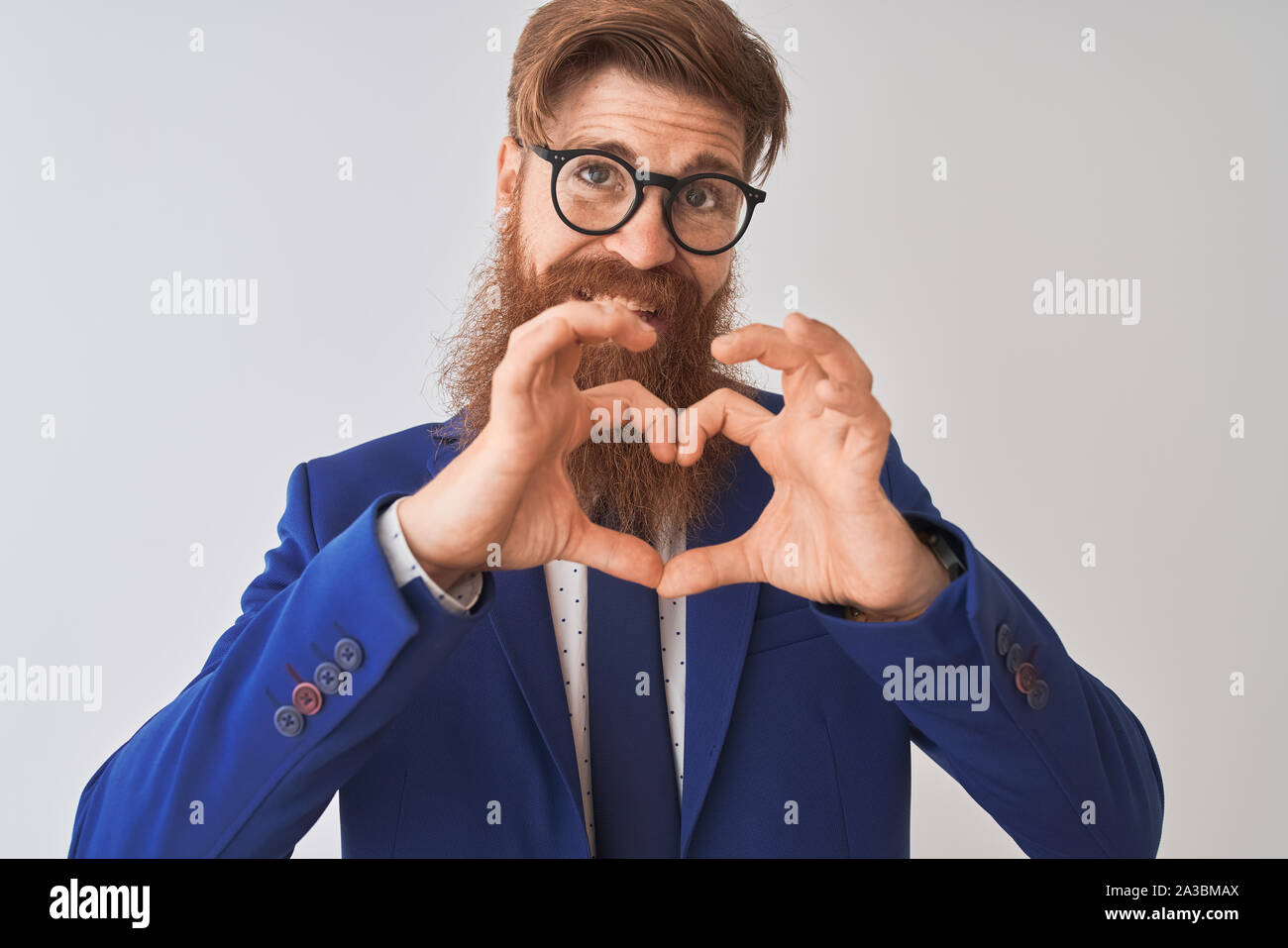 Young redhead irish businessman wearing suit and glasses over isolated ...