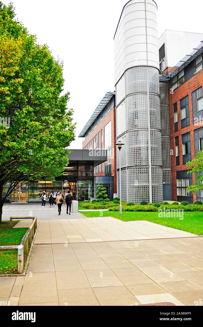 Group of students entering and exiting the Greenbank building of the ...