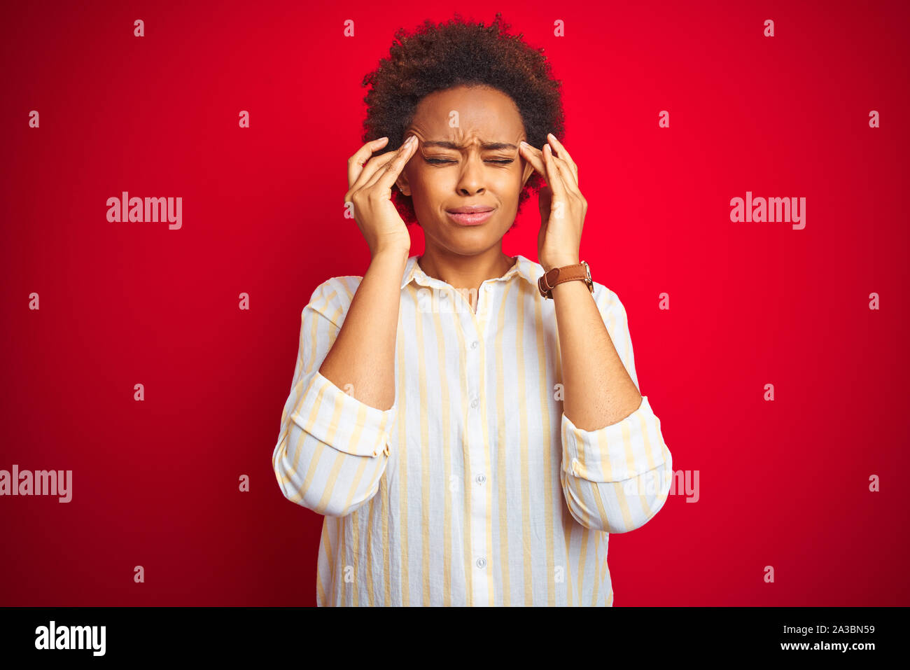 Young beautiful african american woman with afro hair over isolated red ...