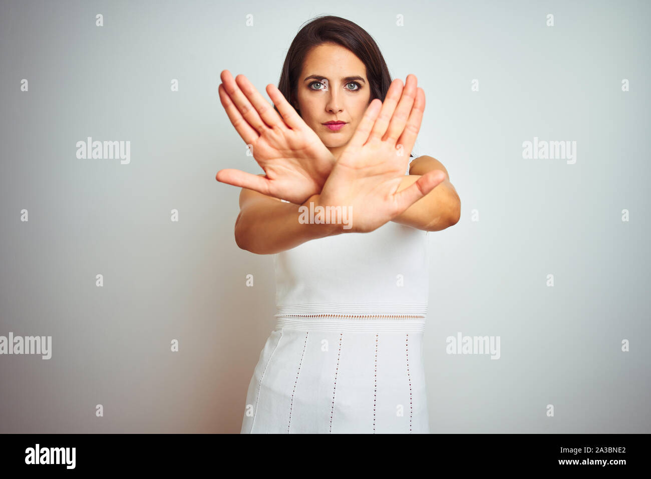Young beautiful woman wearing dress standing over white isolated ...