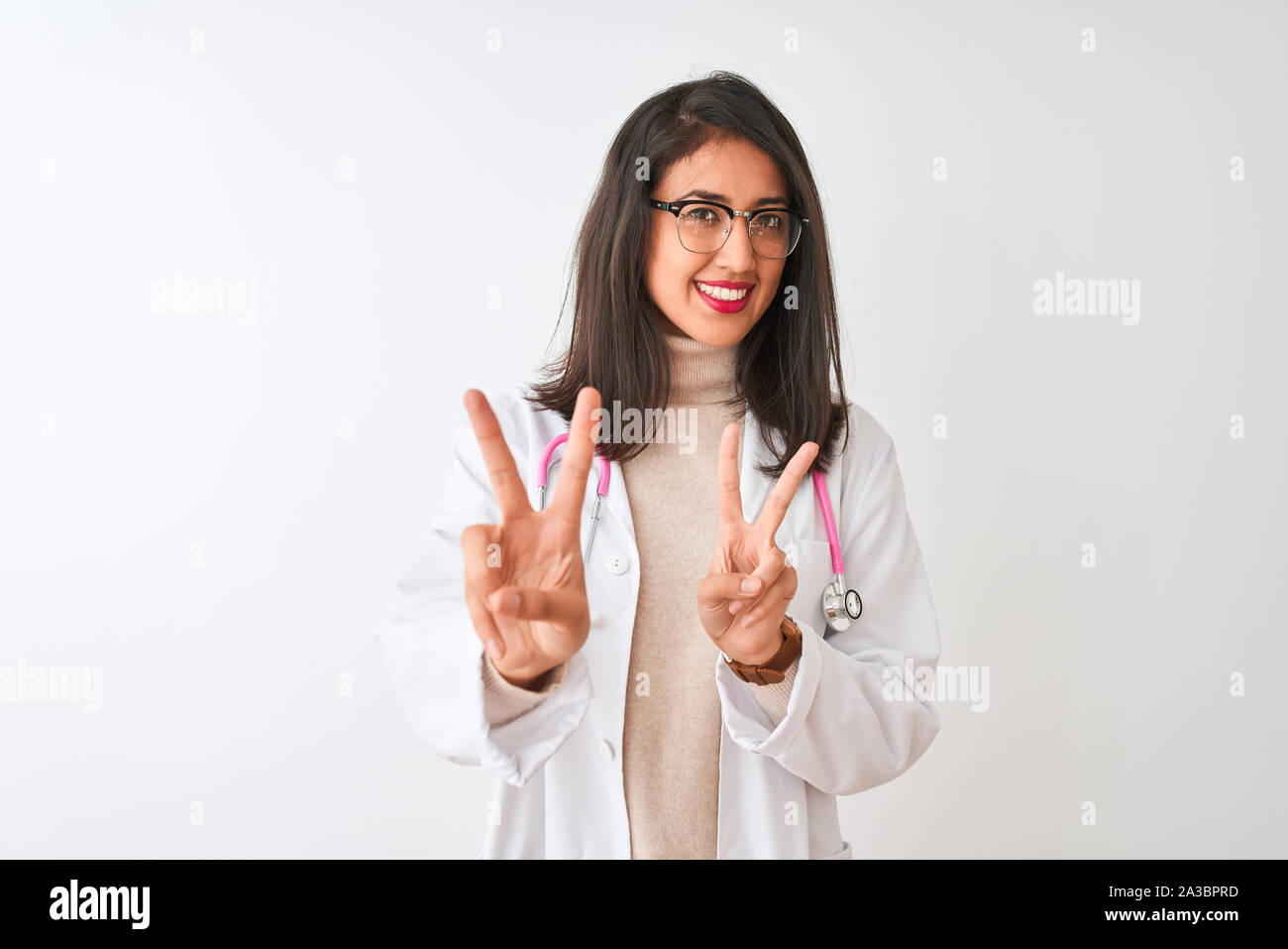 Chinese doctor woman wearing coat and pink stethoscope over isolated ...