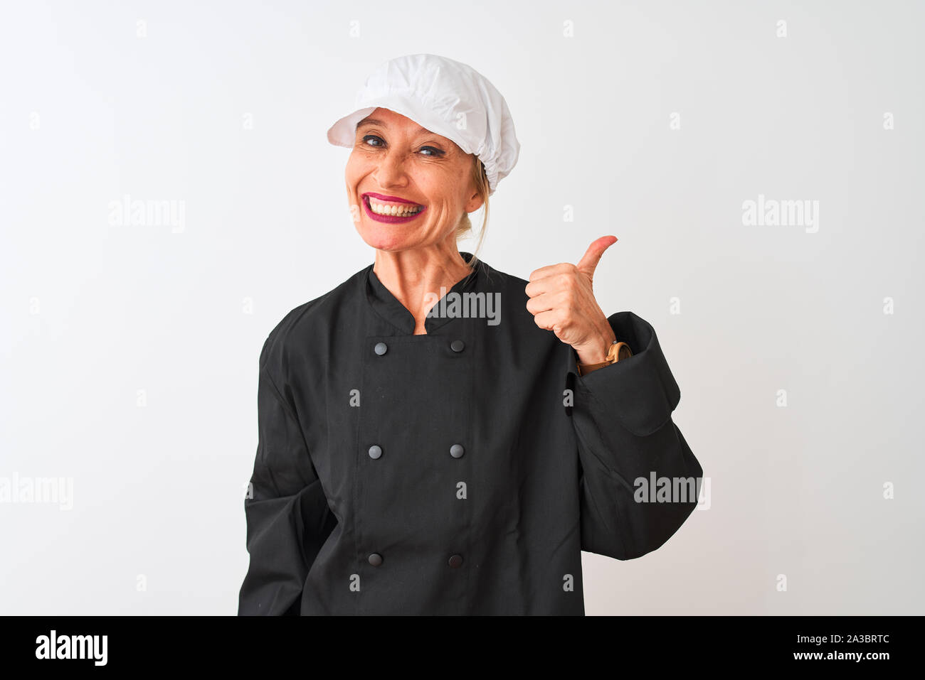 Middle age chef woman wearing uniform and cap standing over isolated ...
