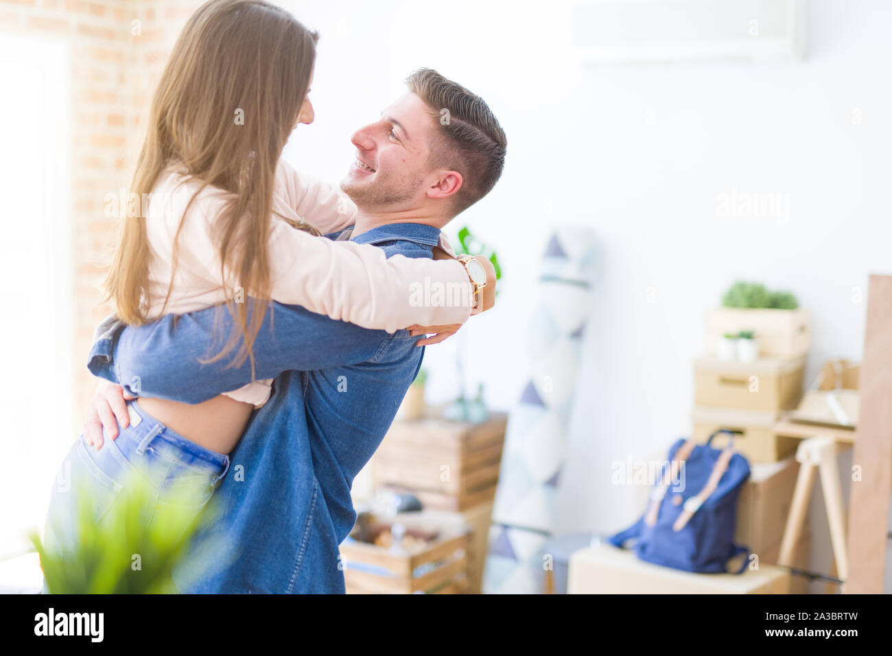 Beautiful young couple hugging in love, very happy moving to a new ...