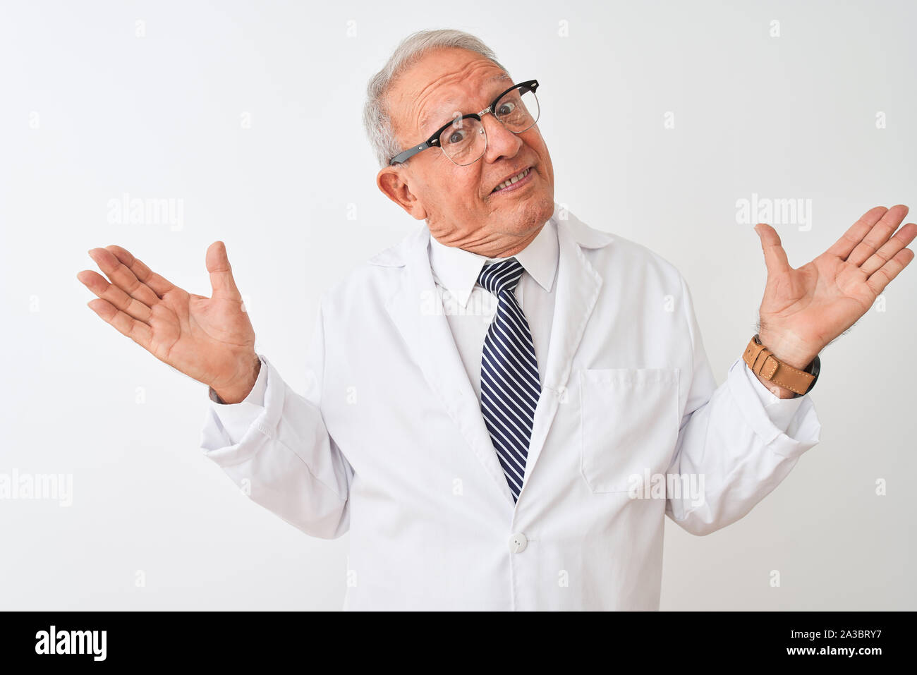 Senior grey-haired scientist man wearing coat standing over isolated ...
