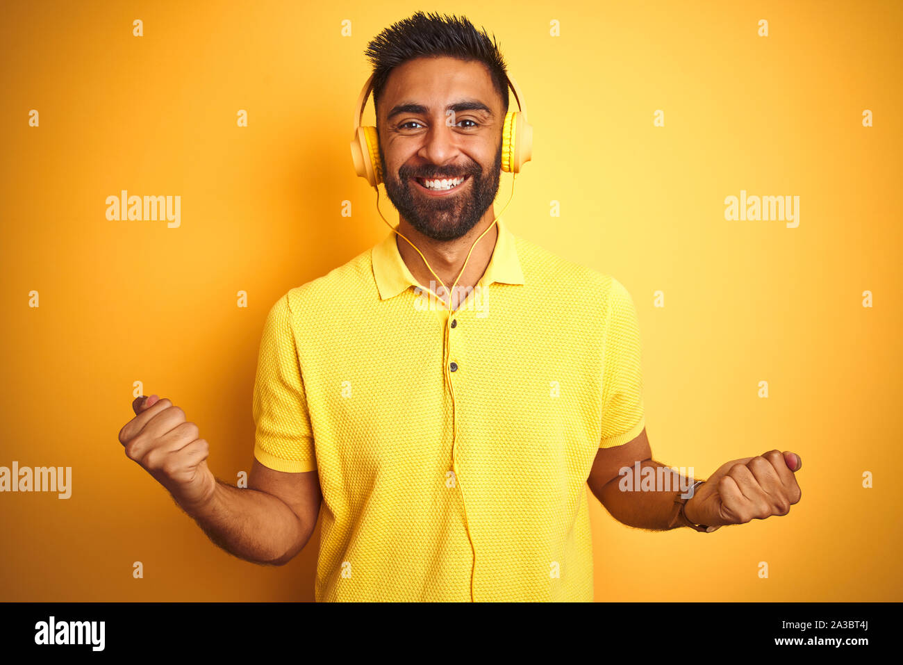 Arab indian hispanic man listening to music using headphones over ...