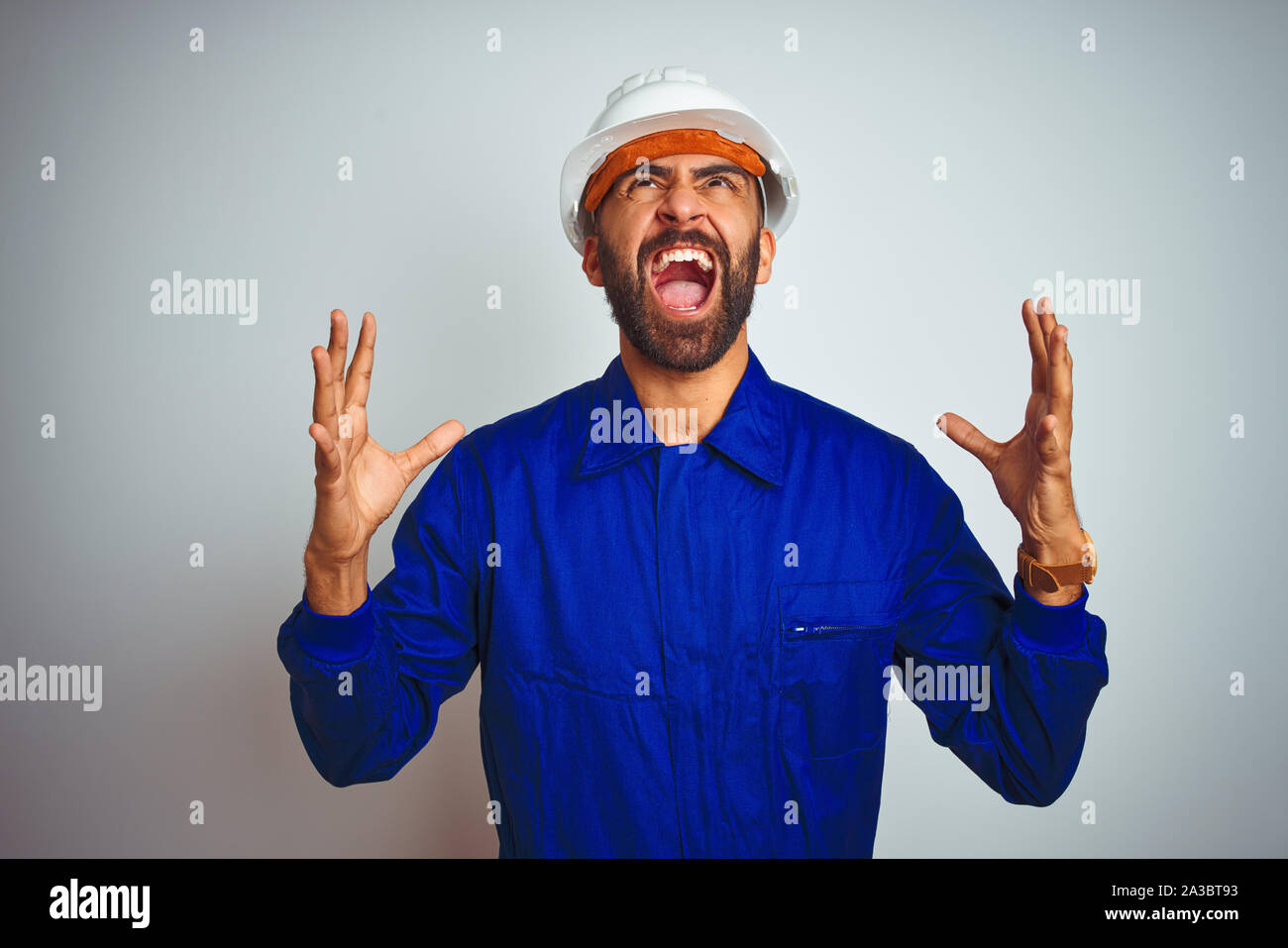 Handsome indian worker man wearing uniform and helmet over isolated ...