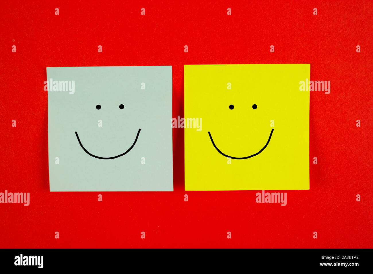 Two friends together. Two pieces of paper with happy smile Stock Photo ...
