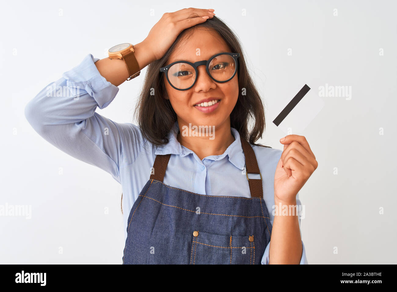 Chinese shopkeeper woman wearing glasses holding credit card over ...