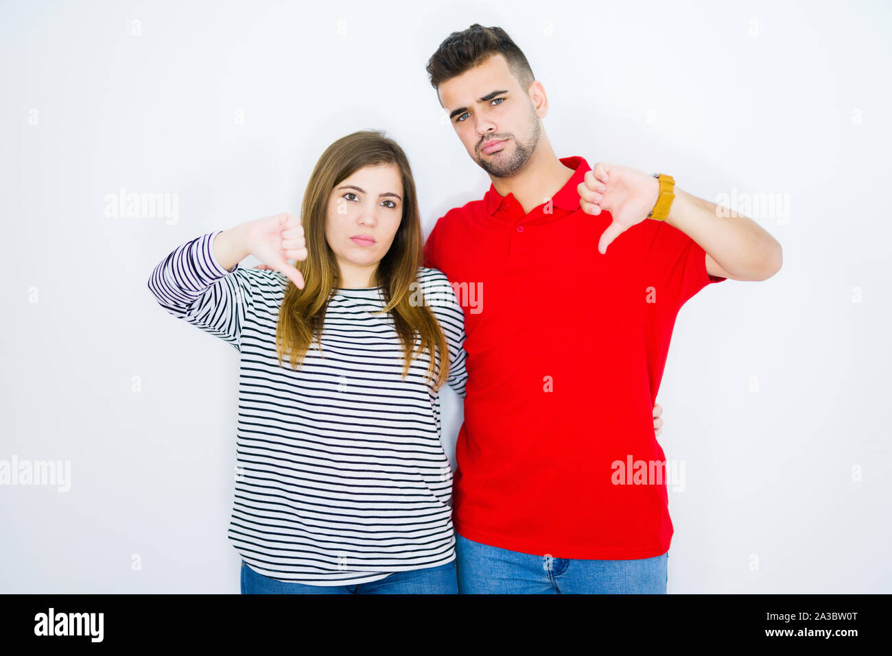 Young beautiful couple hugging together over white isolated background ...