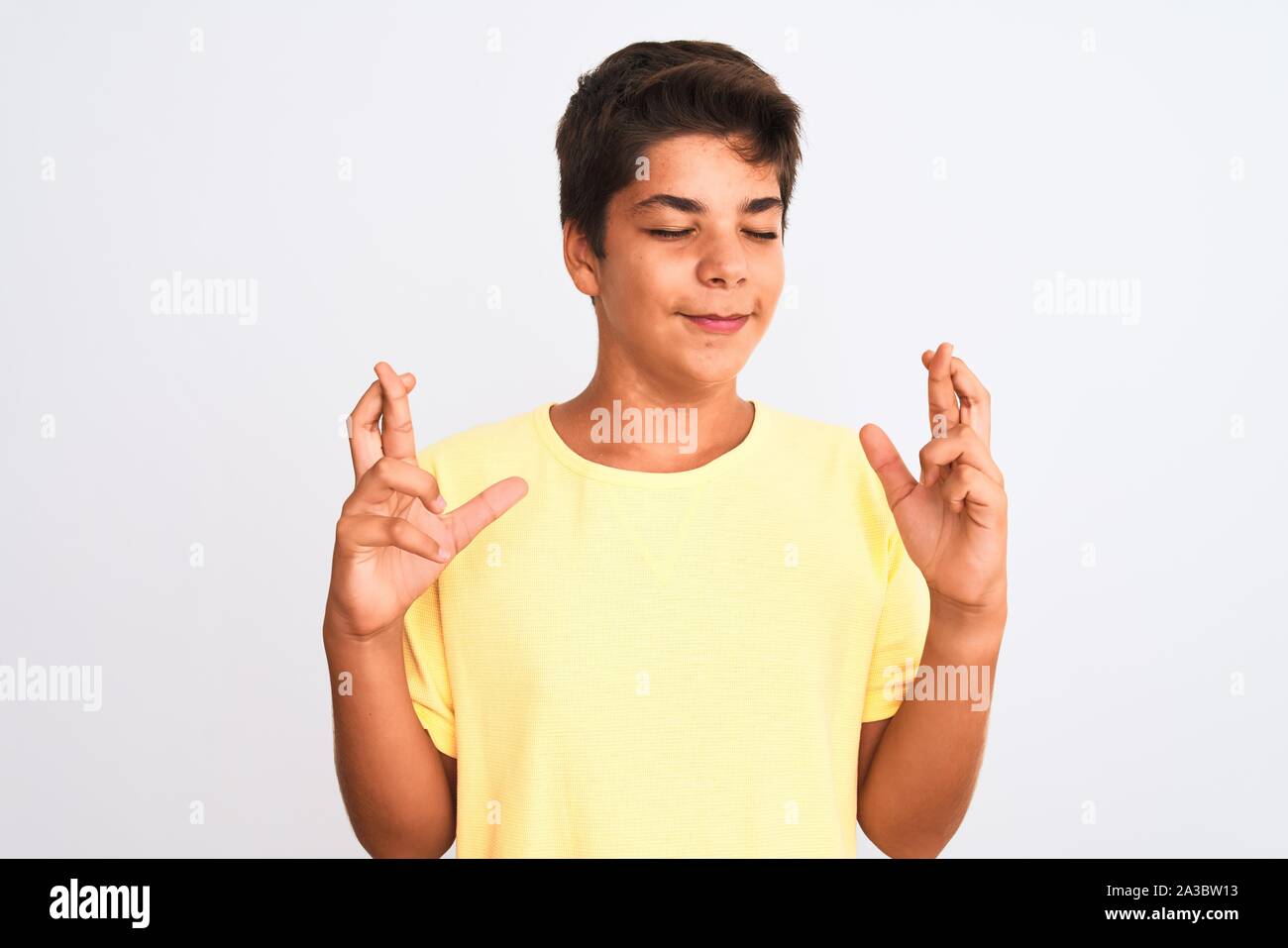 Handsome teenager boy standing over white isolated background gesturing ...