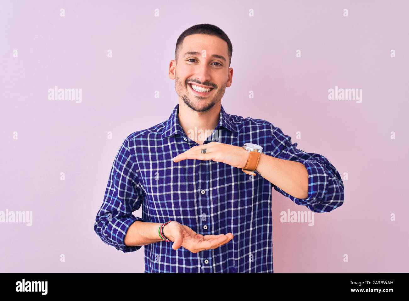 Young handsome man standing over isolated background gesturing with ...