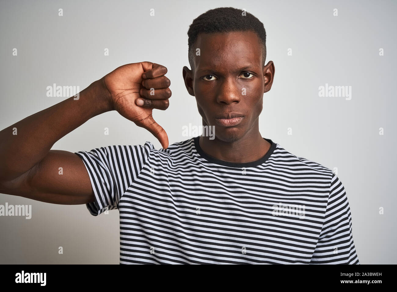 African american man wearing navy striped t-shirt standing over ...