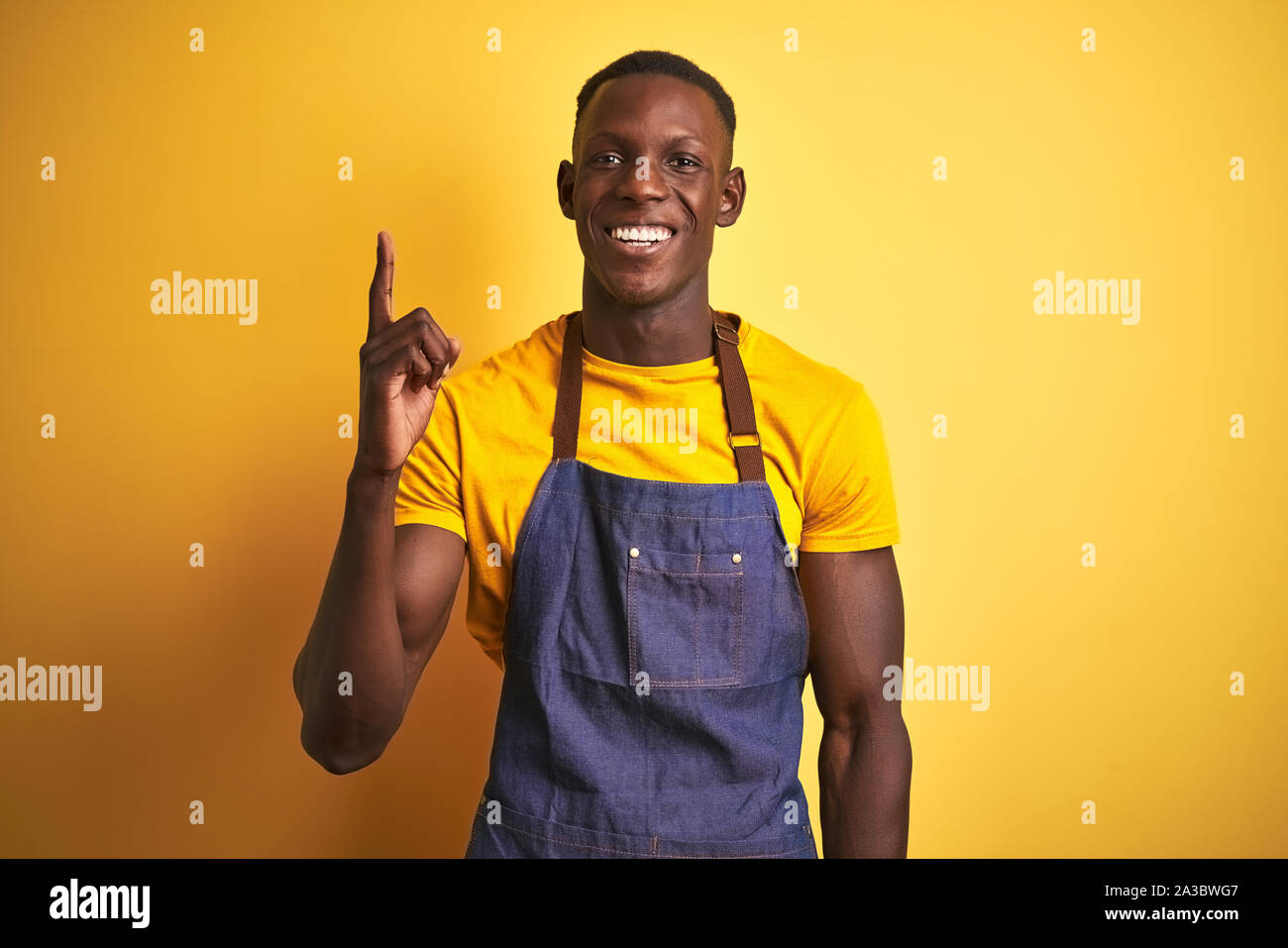 African american bartender man wearing apron standing over isolated ...
