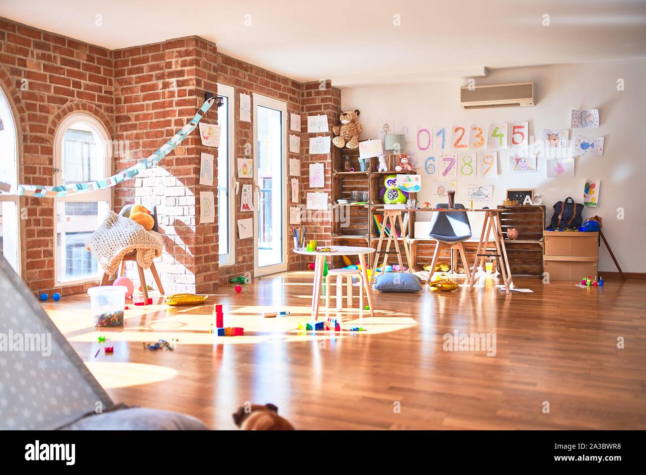 Picture of preschool playroom with colorful furniture and toys around ...