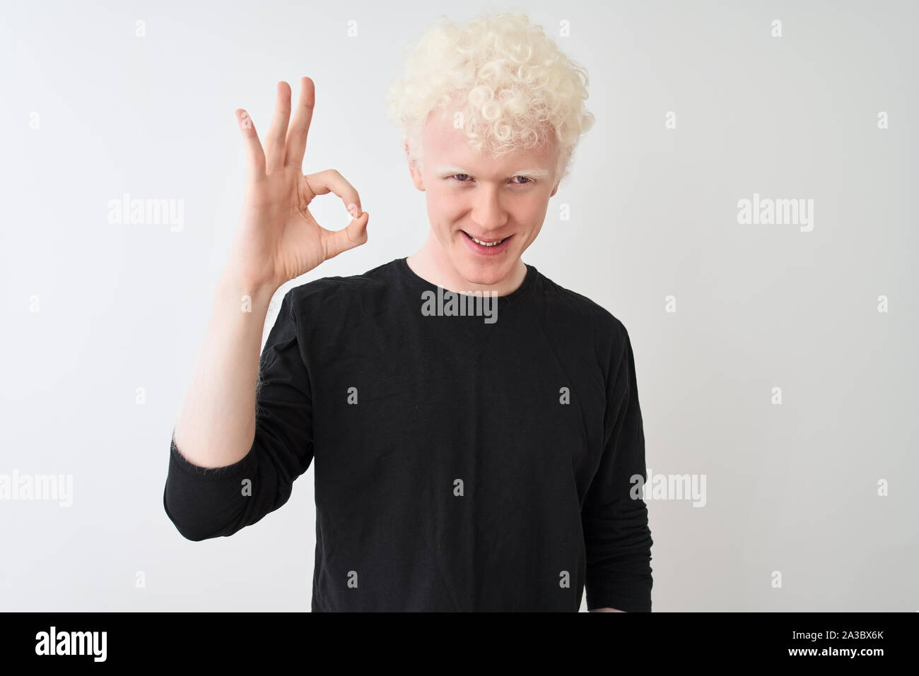 Young albino blond man wearing black t-shirt standing over isolated ...