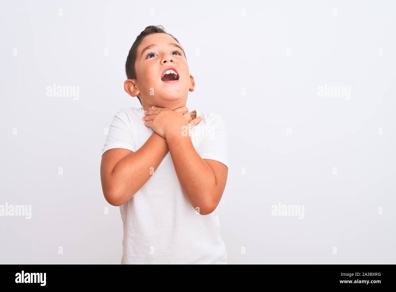 Beautiful kid boy wearing casual t-shirt standing over isolated white ...
