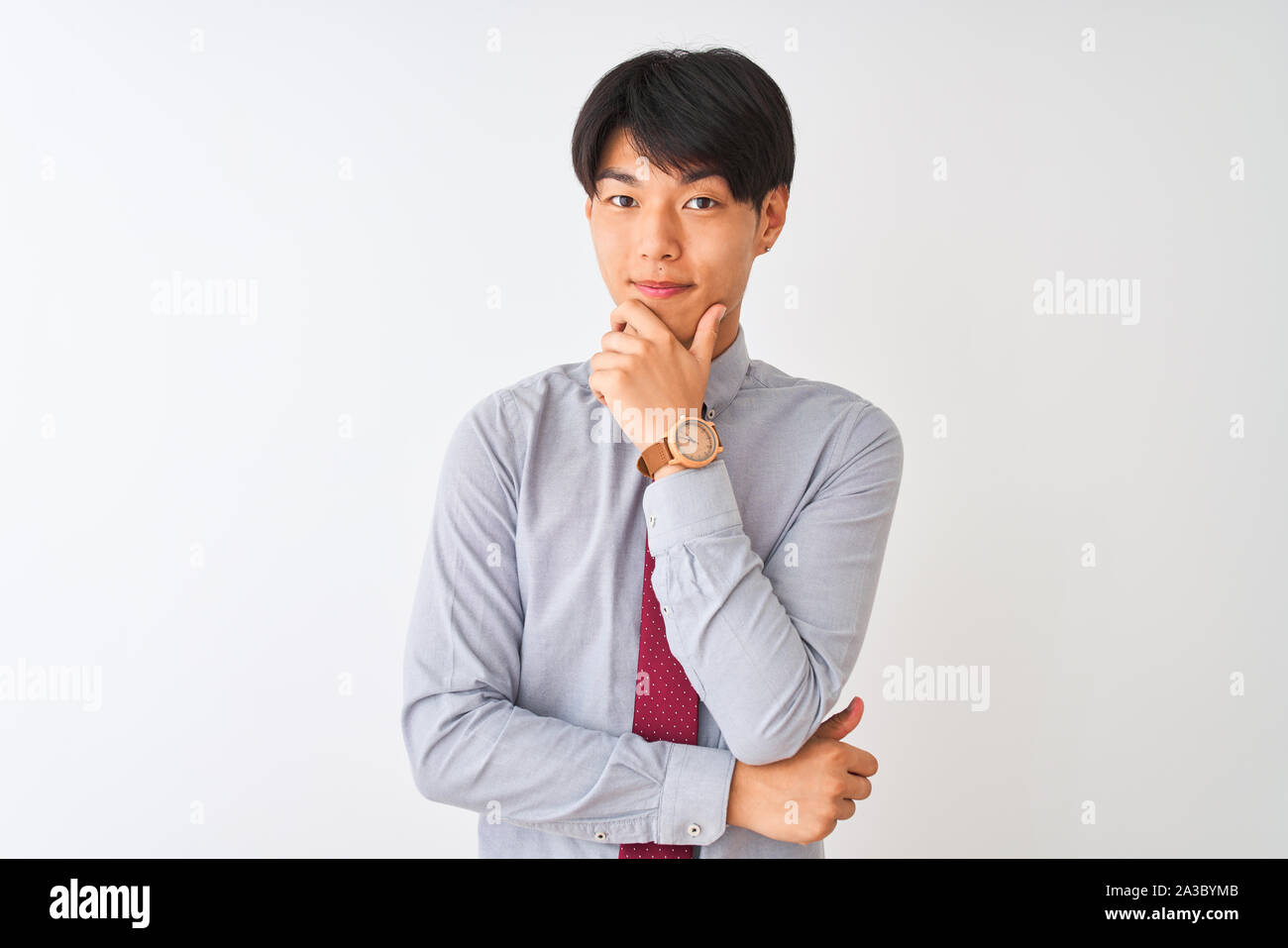 Chinese businessman wearing elegant tie standing over isolated white ...