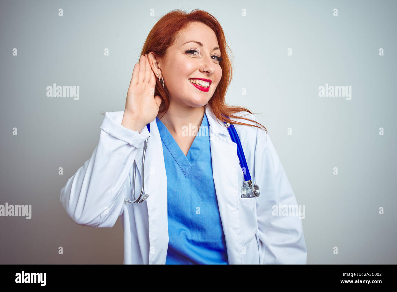 Young redhead doctor woman using stethoscope over white isolated ...