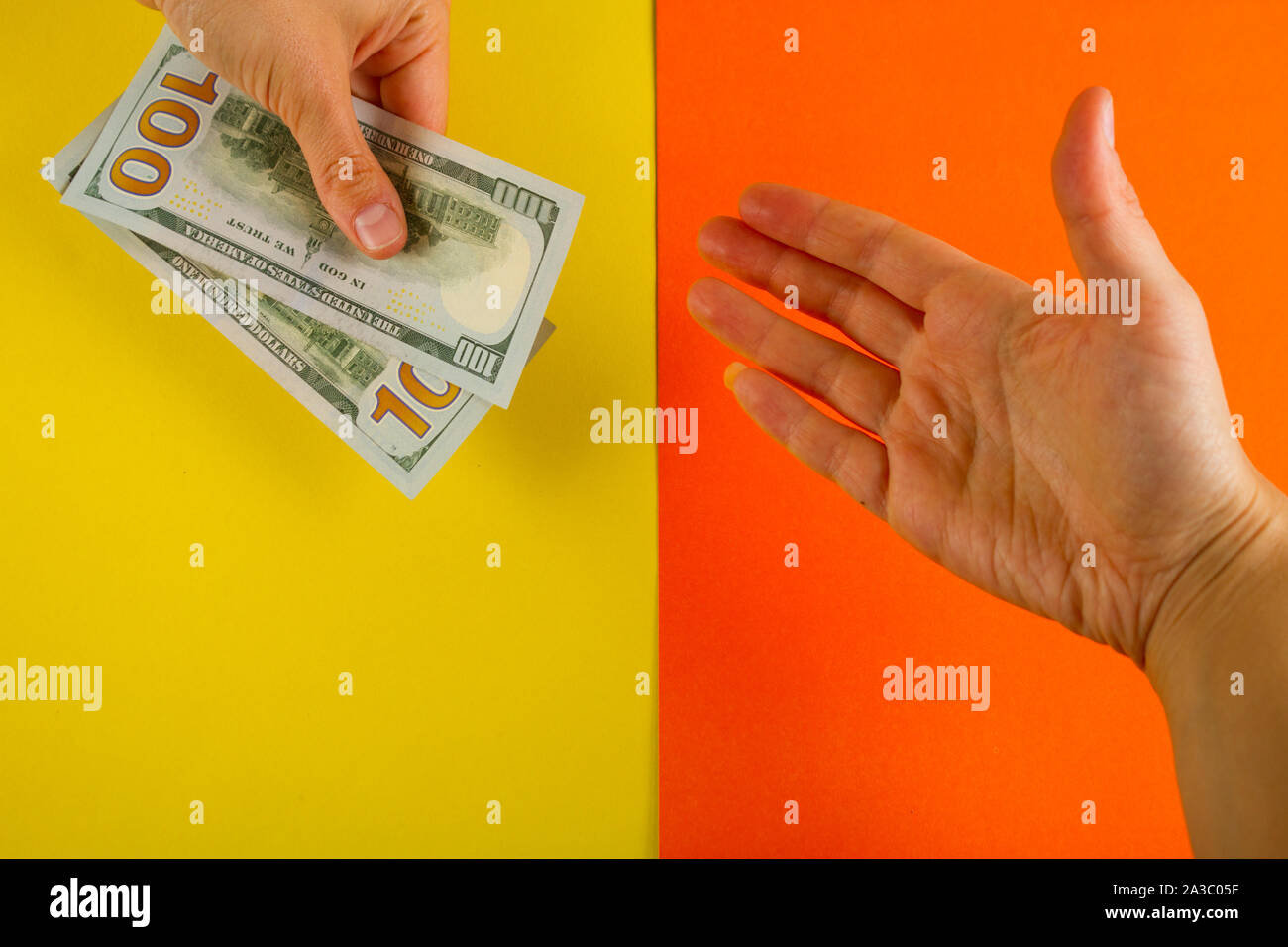 Human hands exchanging money on colorful background Stock Photo - Alamy