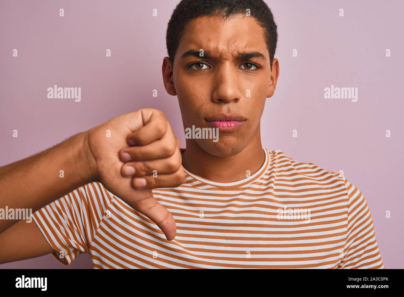 Young Handsome Arab Man Wearing Striped T Shirt Standing Over Isolated
