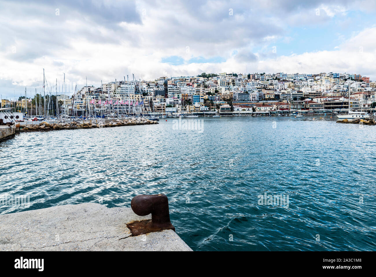 Old rusty metal moorage in the port of Athens, Greece with the city in ...