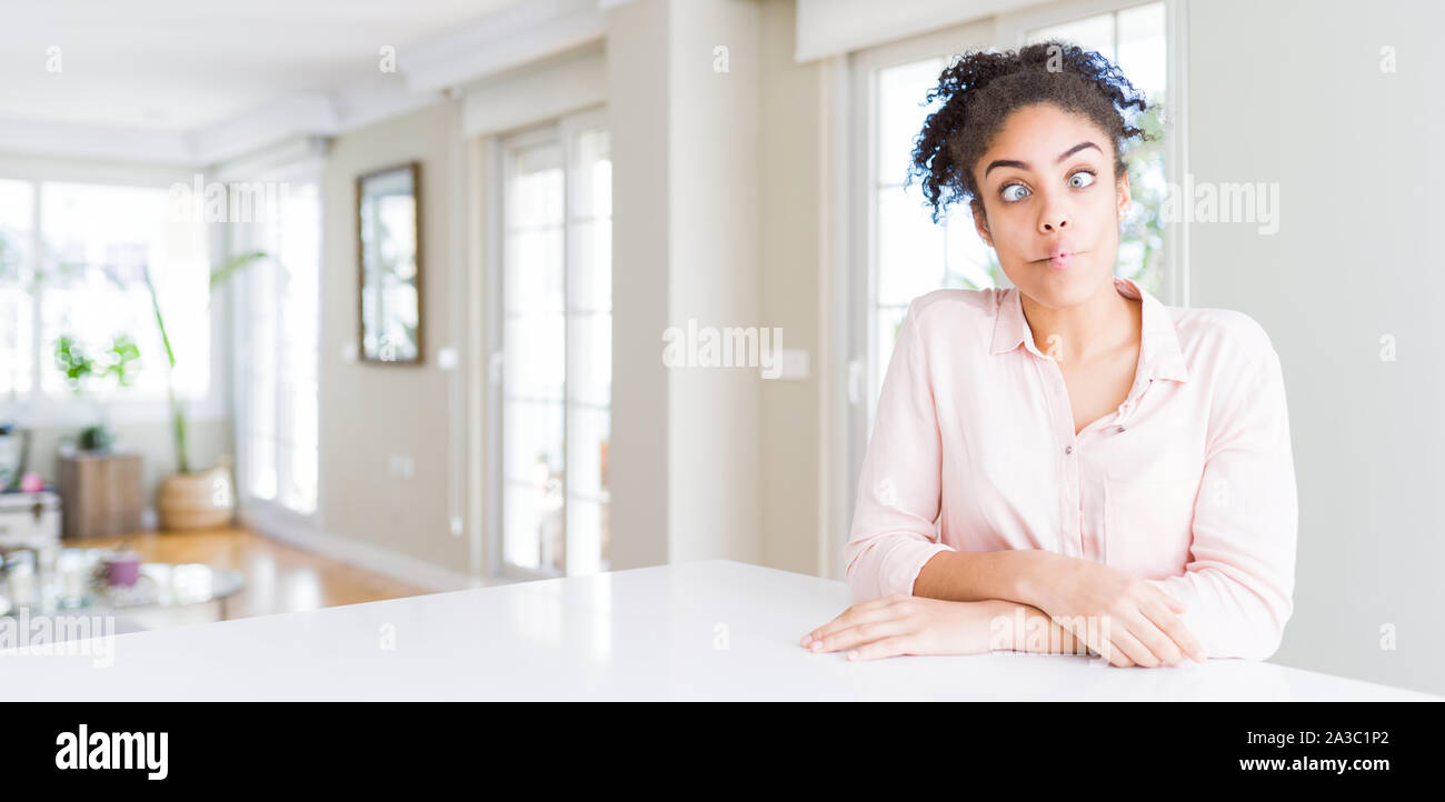 Wide angle of beautiful african american woman with afro hair making ...