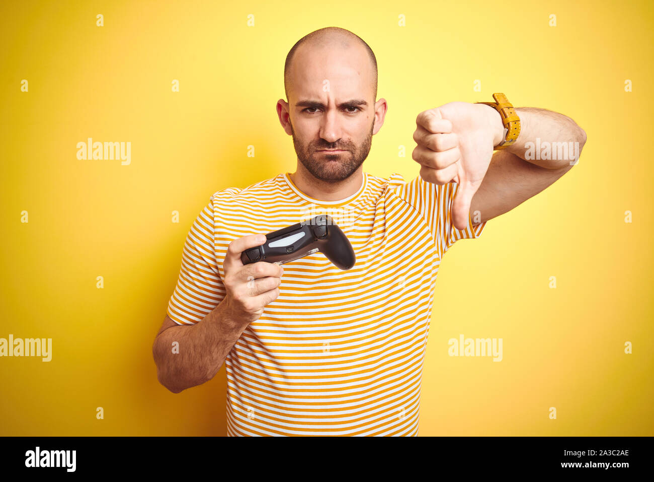 Young man playing video games using joystick gamepad over isolated ...