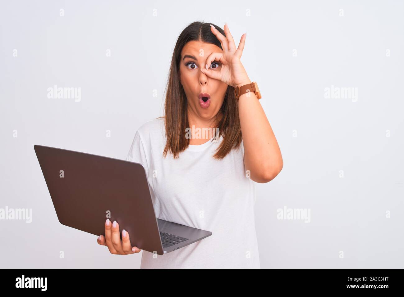 Beautiful young woman working using computer laptop over white ...