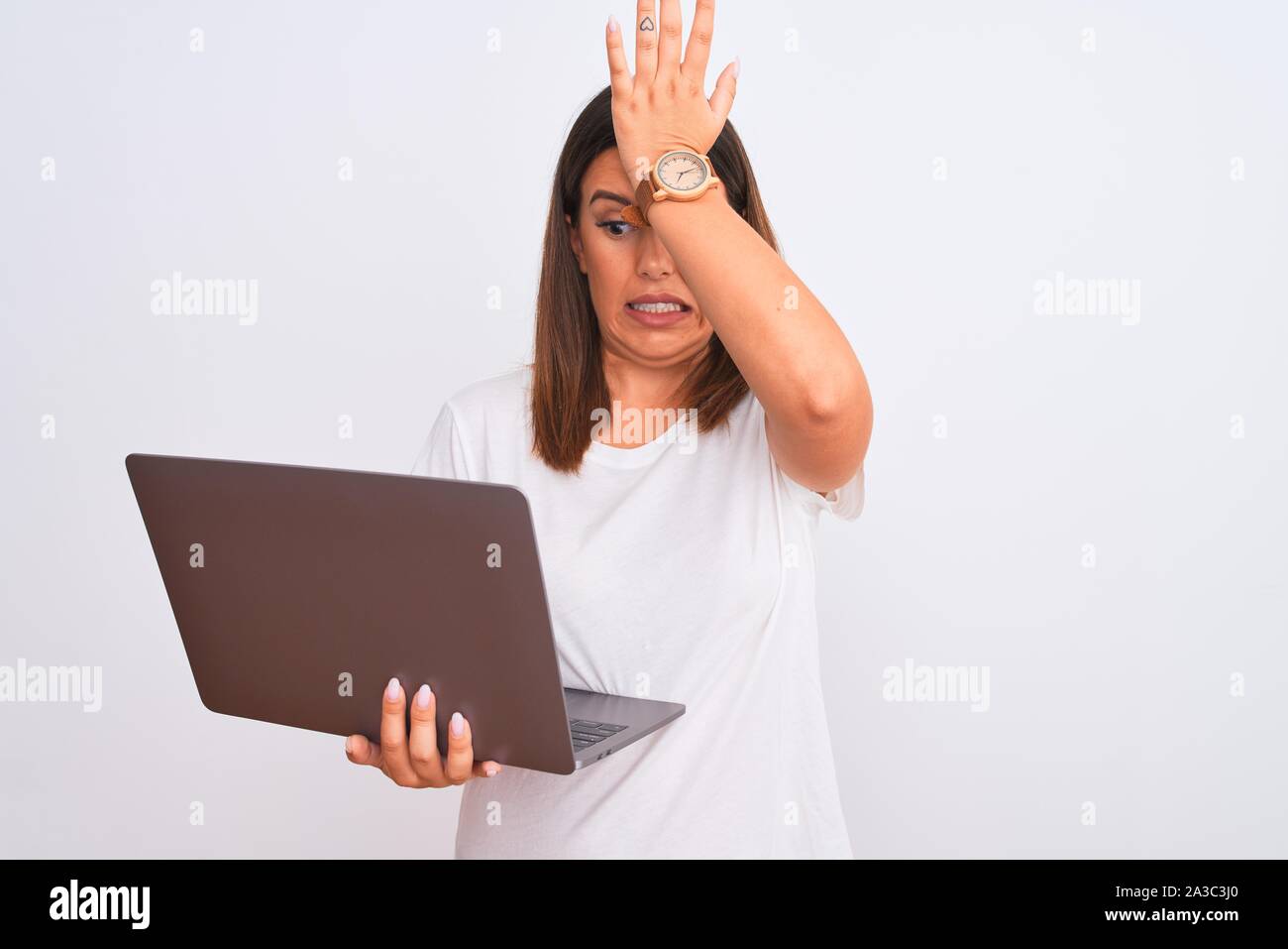 Beautiful young woman working using computer laptop over white ...