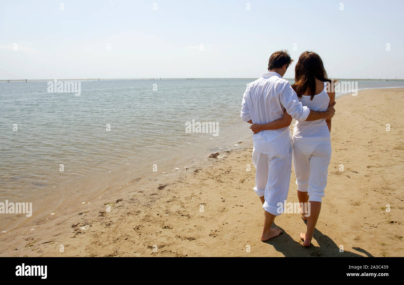 Back view two women hug beach hi-res stock photography and images - Alamy