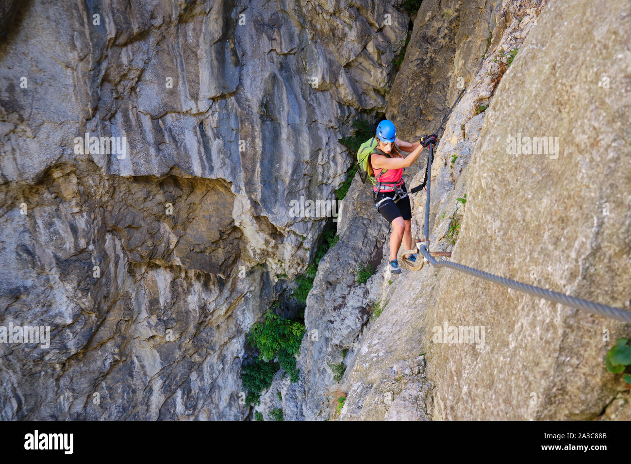 Female tourist traversing a via ferrata section in Turda gorge (Cheile ...