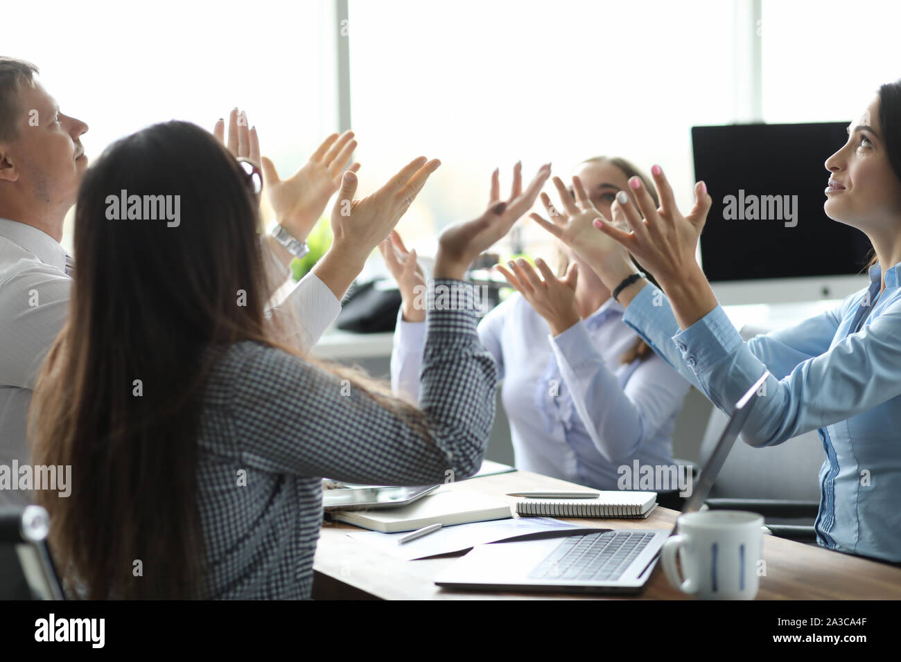 Team of business people raise hand from office background Stock Photo ...