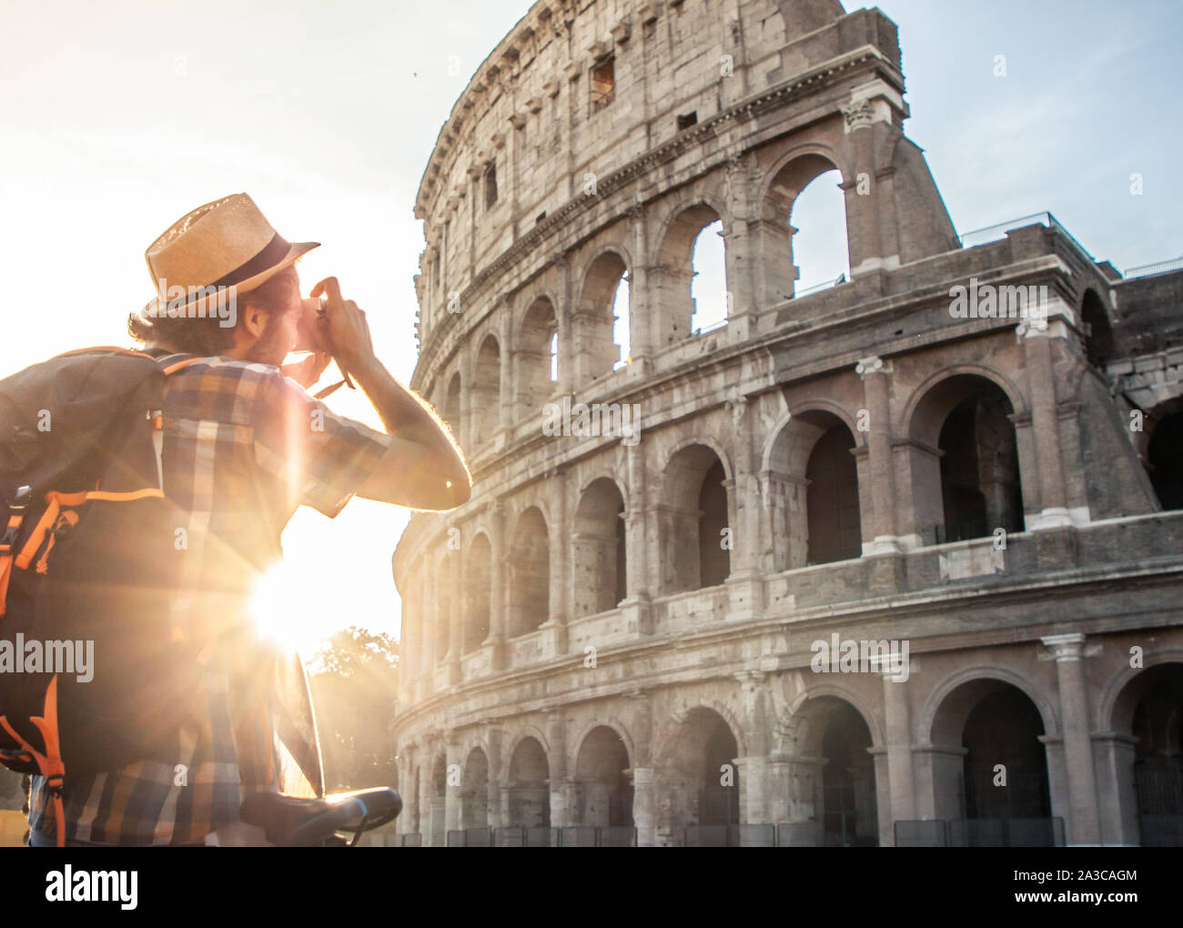Happy young man tourist wearing shirt and hat taking pictures with ...