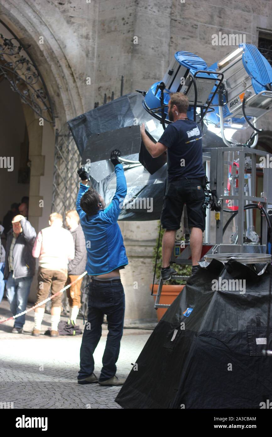 Illuminator arrranging big headlight to light up film scene Stock Photo ...