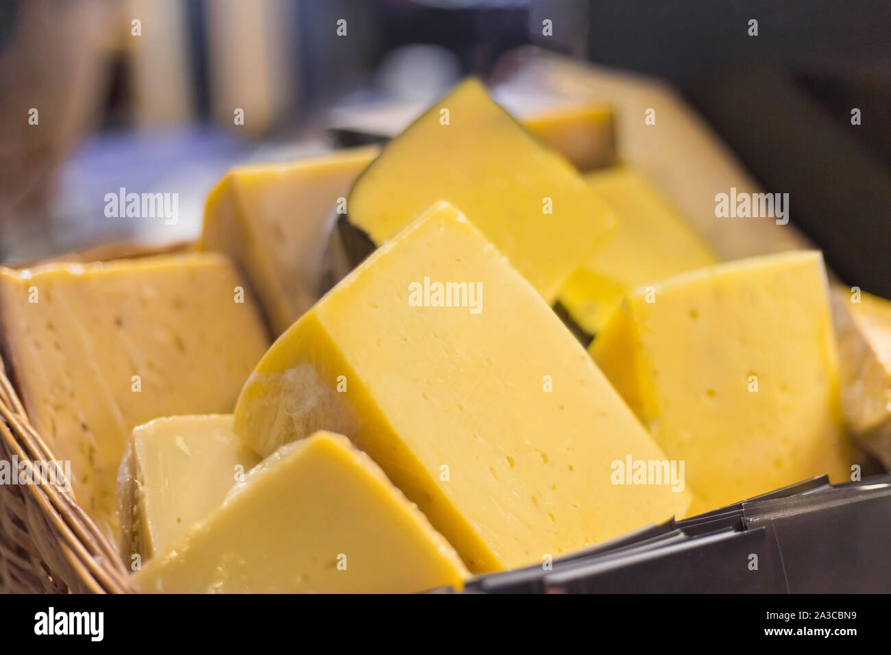 Delicious handmade yellow cheeses for sale on counter Stock Photo - Alamy